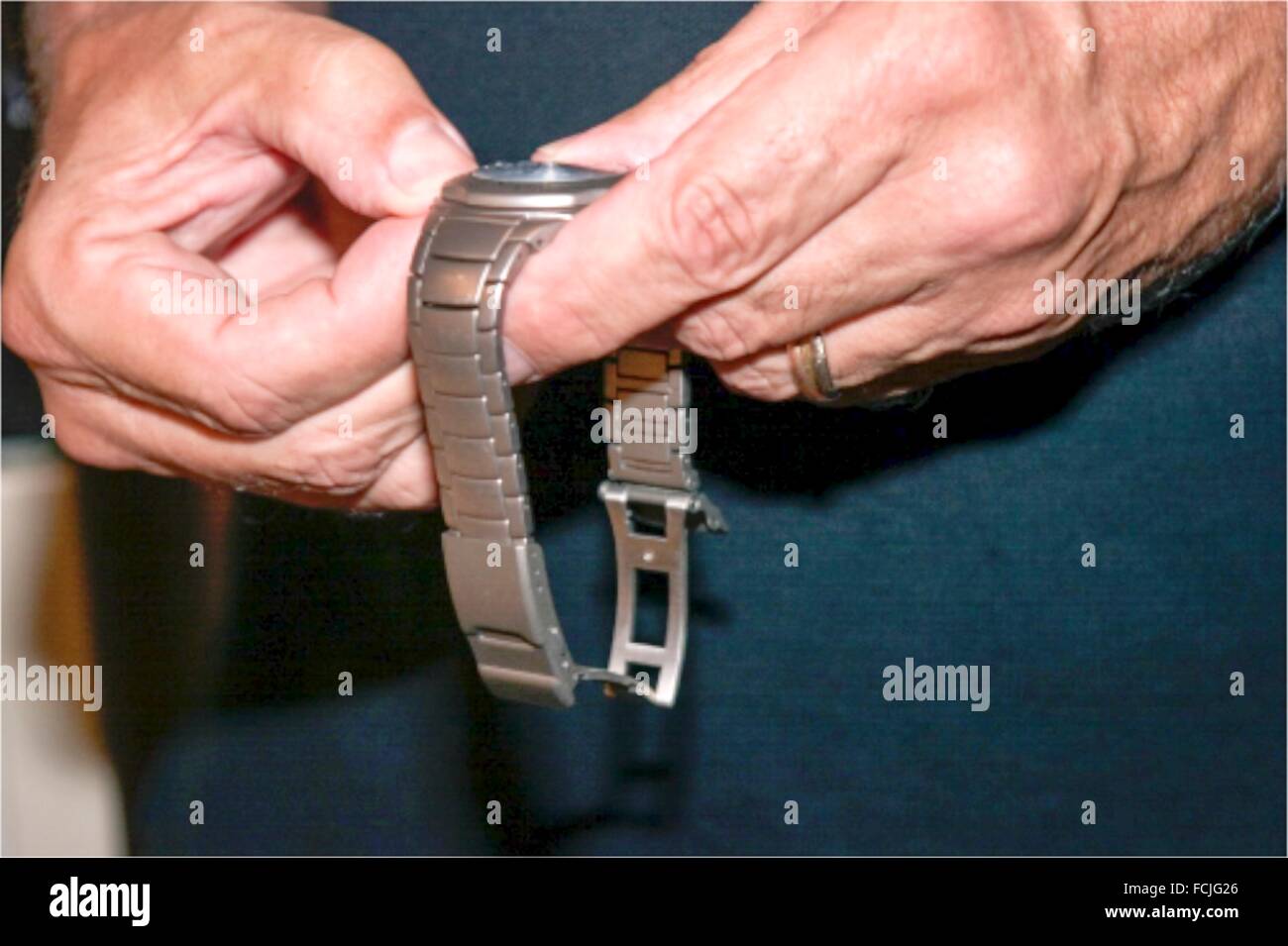 Senior man setting a watch Stock Photo - Alamy