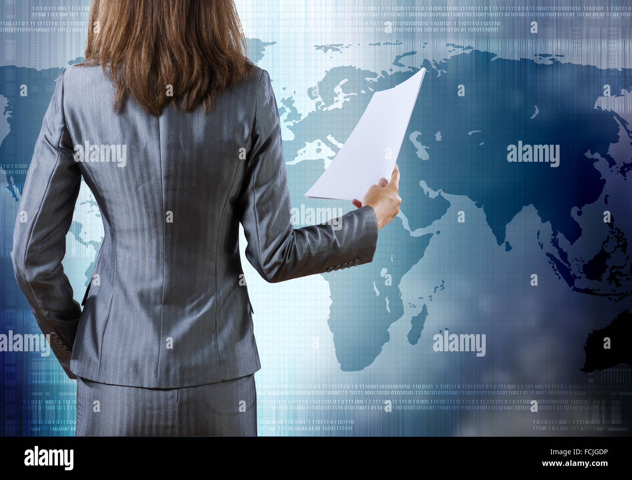 Rear view of businesswoman against digital blue background Stock Photo ...