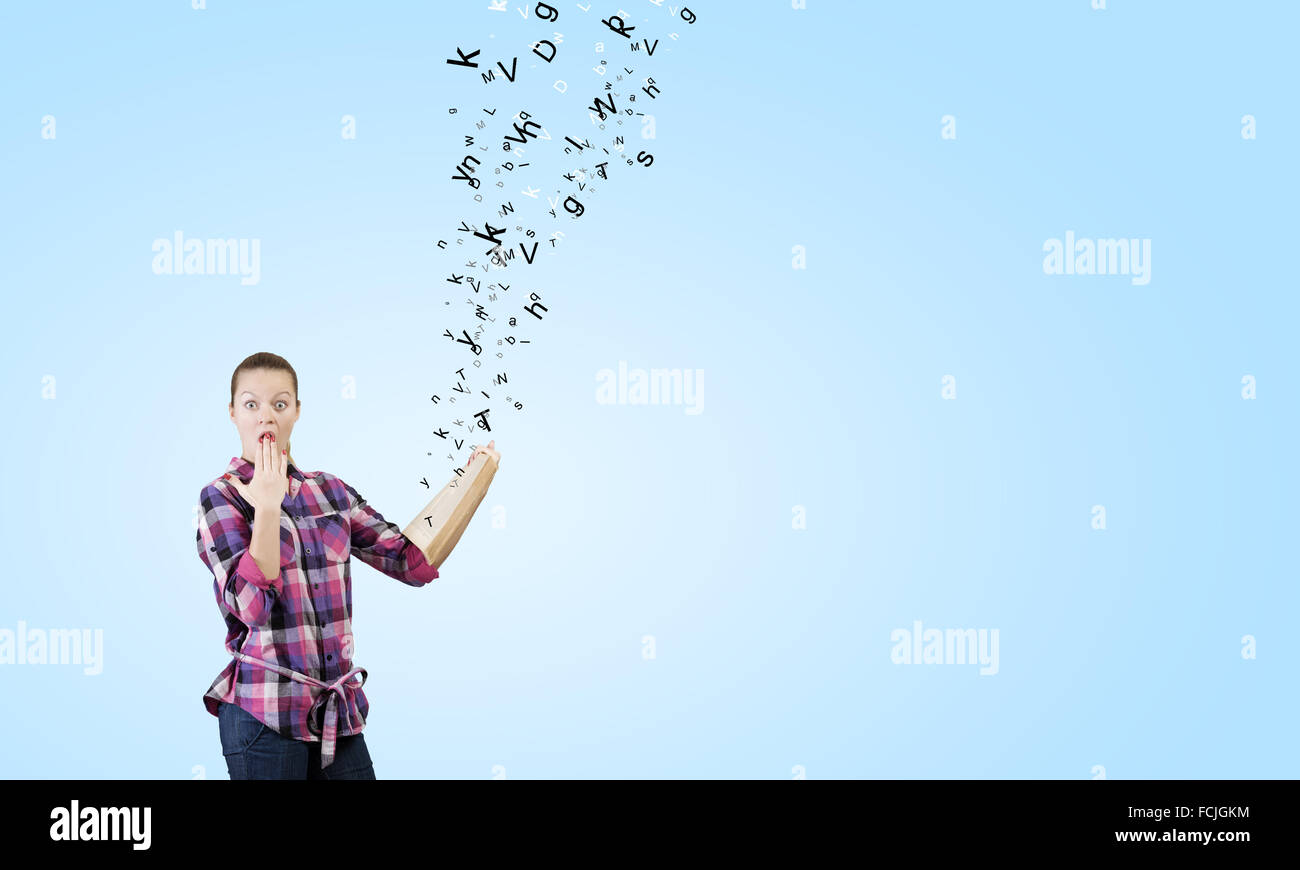 Woman shock reading book library hi-res stock photography and images ...