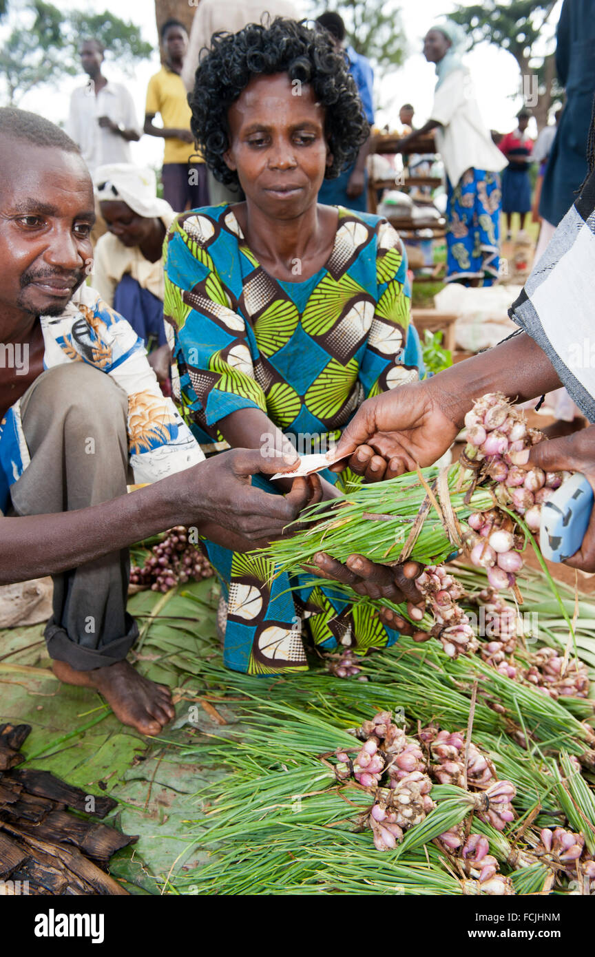 Trading at a roadside market with traders selling food items. Uganda ...