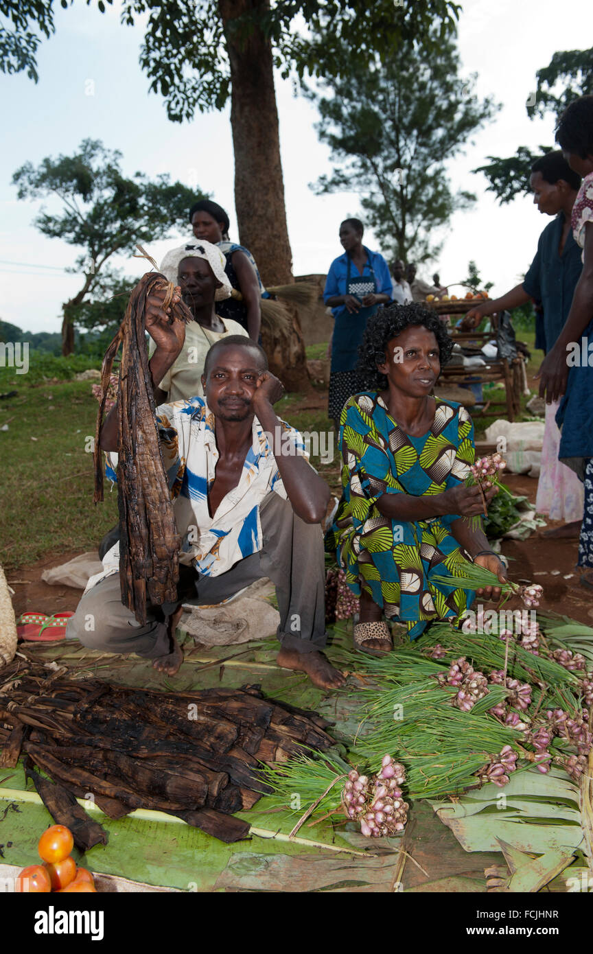 Trading at a roadside market with traders selling food items. Uganda ...