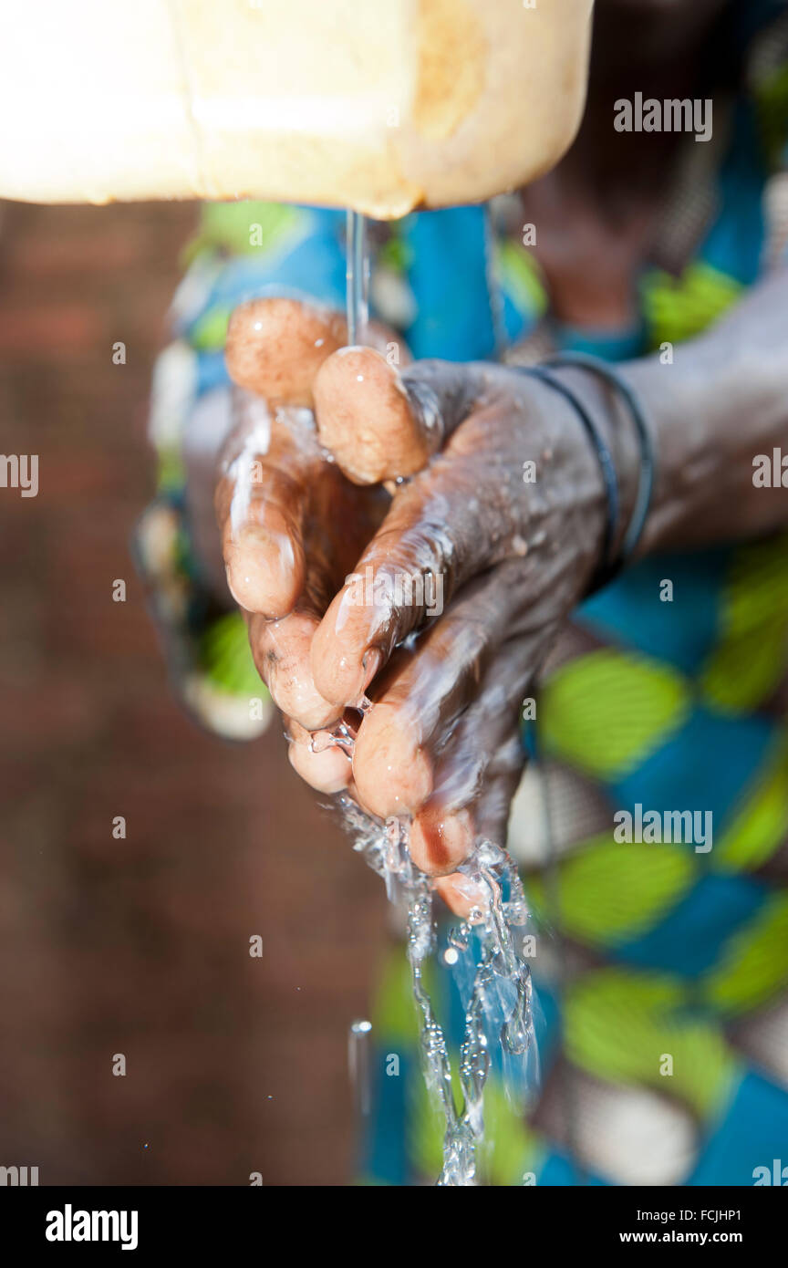 Lady washing hands from a "Tip Tap" an efficent way to clean hands ...