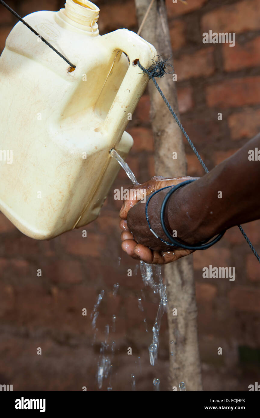 Lady washing hands from a "Tip Tap" an efficent way to clean hands ...