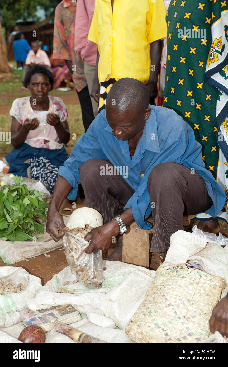 Trading at a roadside market with traders selling food items. Uganda ...