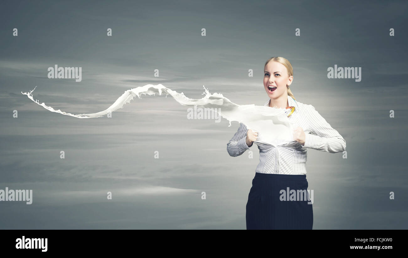 Young woman tearing shirt on chest and splashes flying out Stock Photo ...