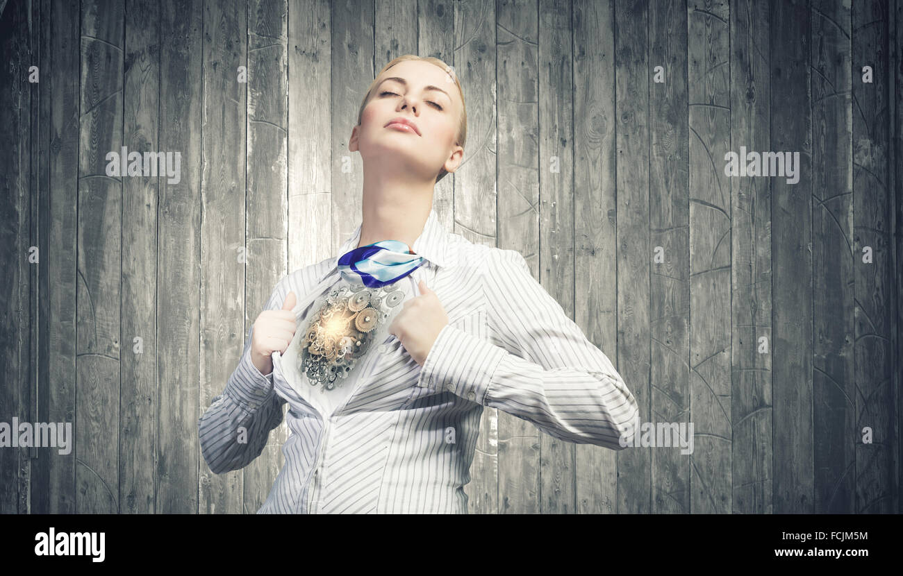 Young woman tearing shirt on chest. Mechanism concept Stock Photo - Alamy