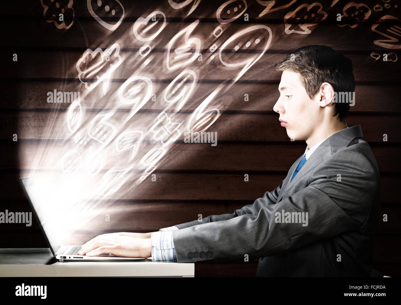 Young man thoughtfully looking in laptop screen Stock Photo - Alamy