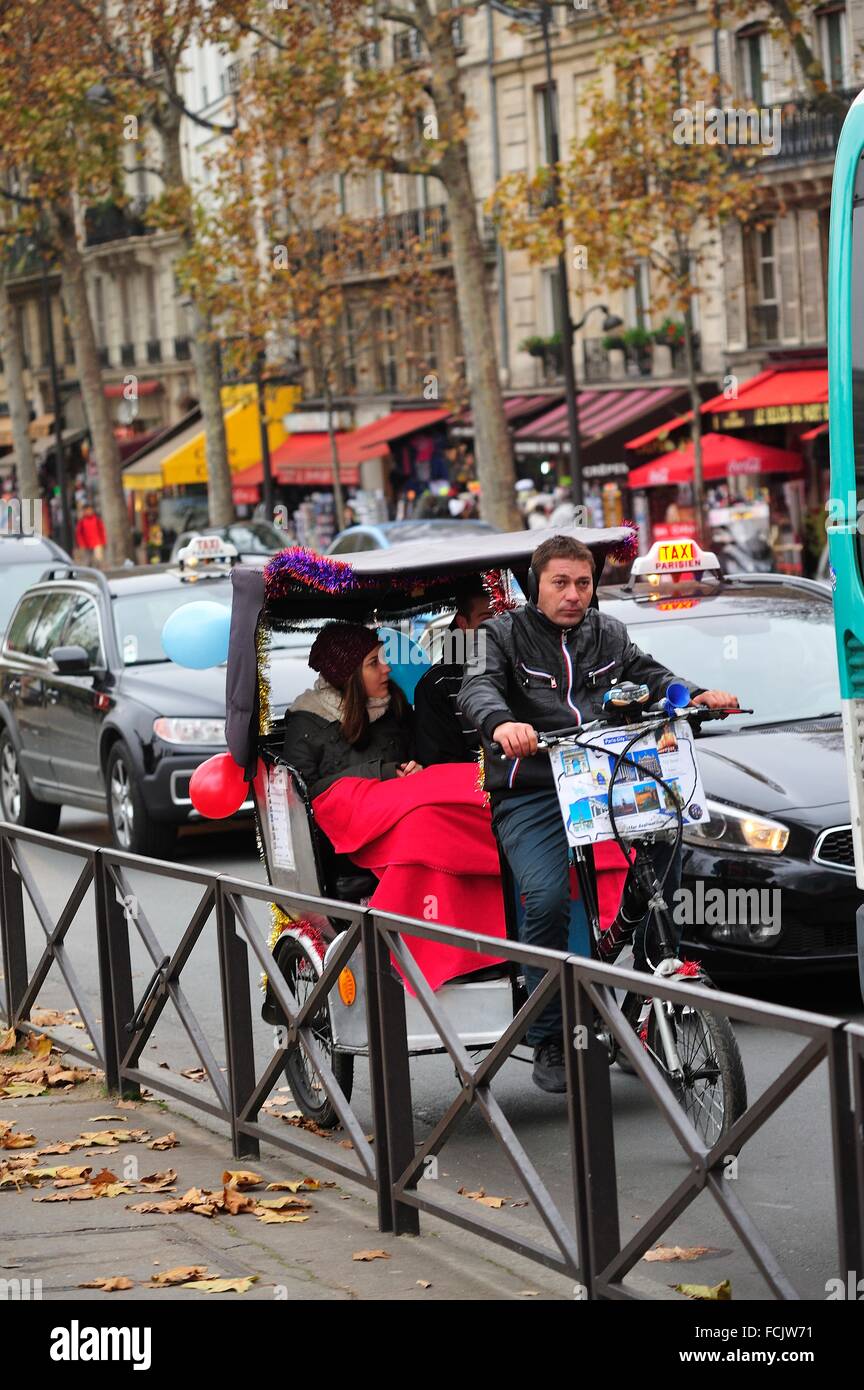 bicycle rickshaw and traffic on Quai du Louvre, Paris, France Stock ...