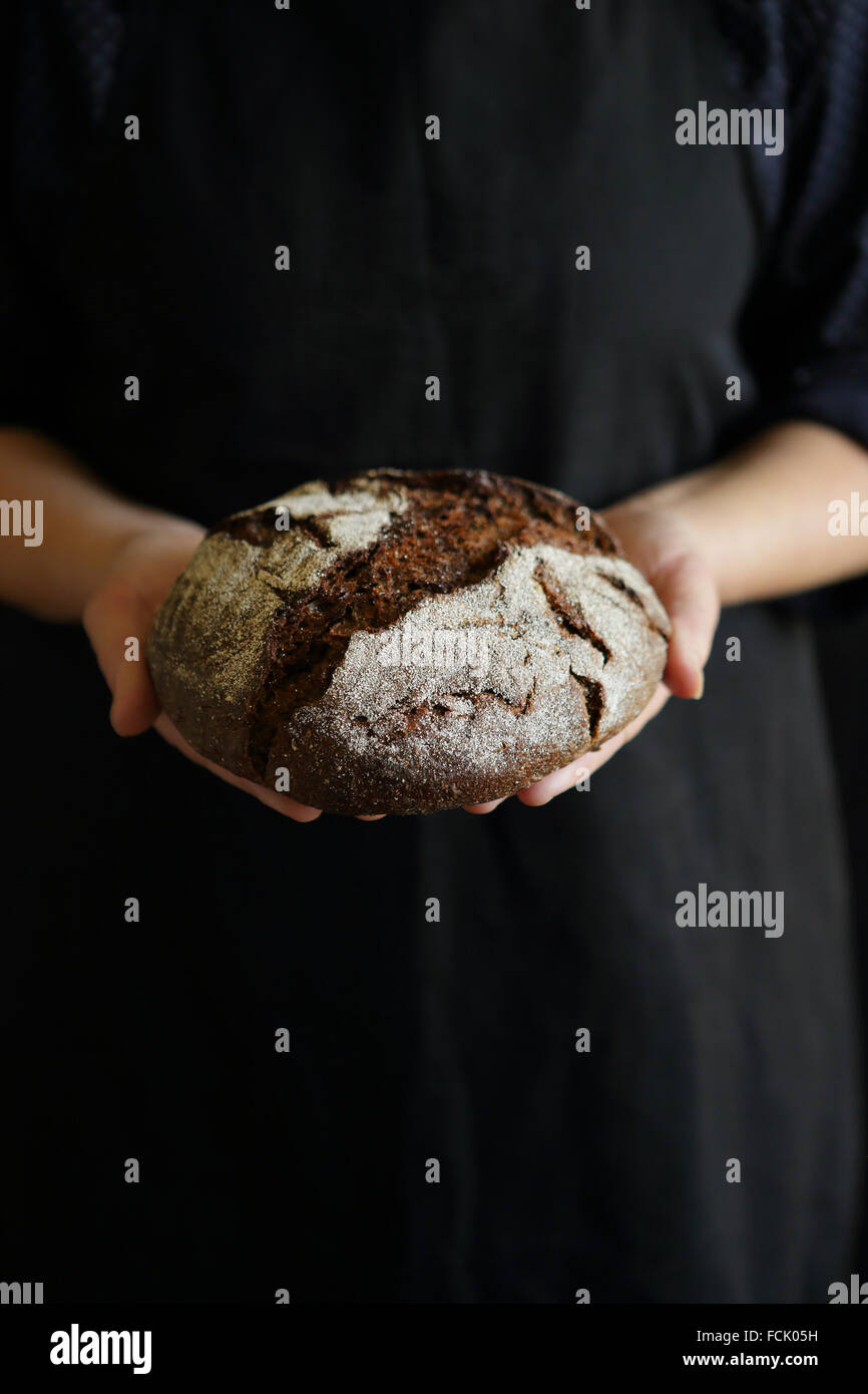 Hands holding loaf bread in hi-res stock photography and images - Alamy