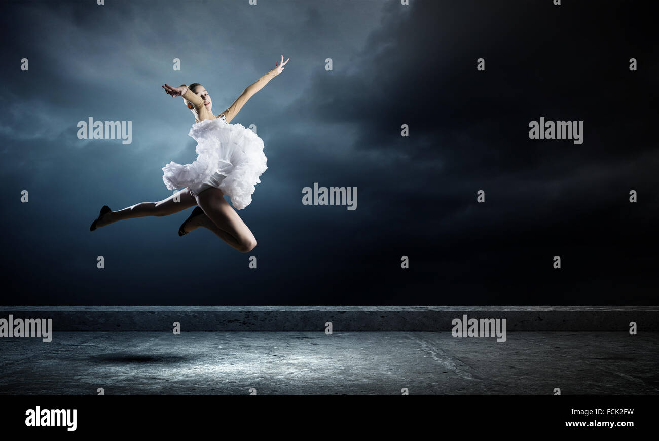 Young girl dancer jumping high in sky Stock Photo - Alamy