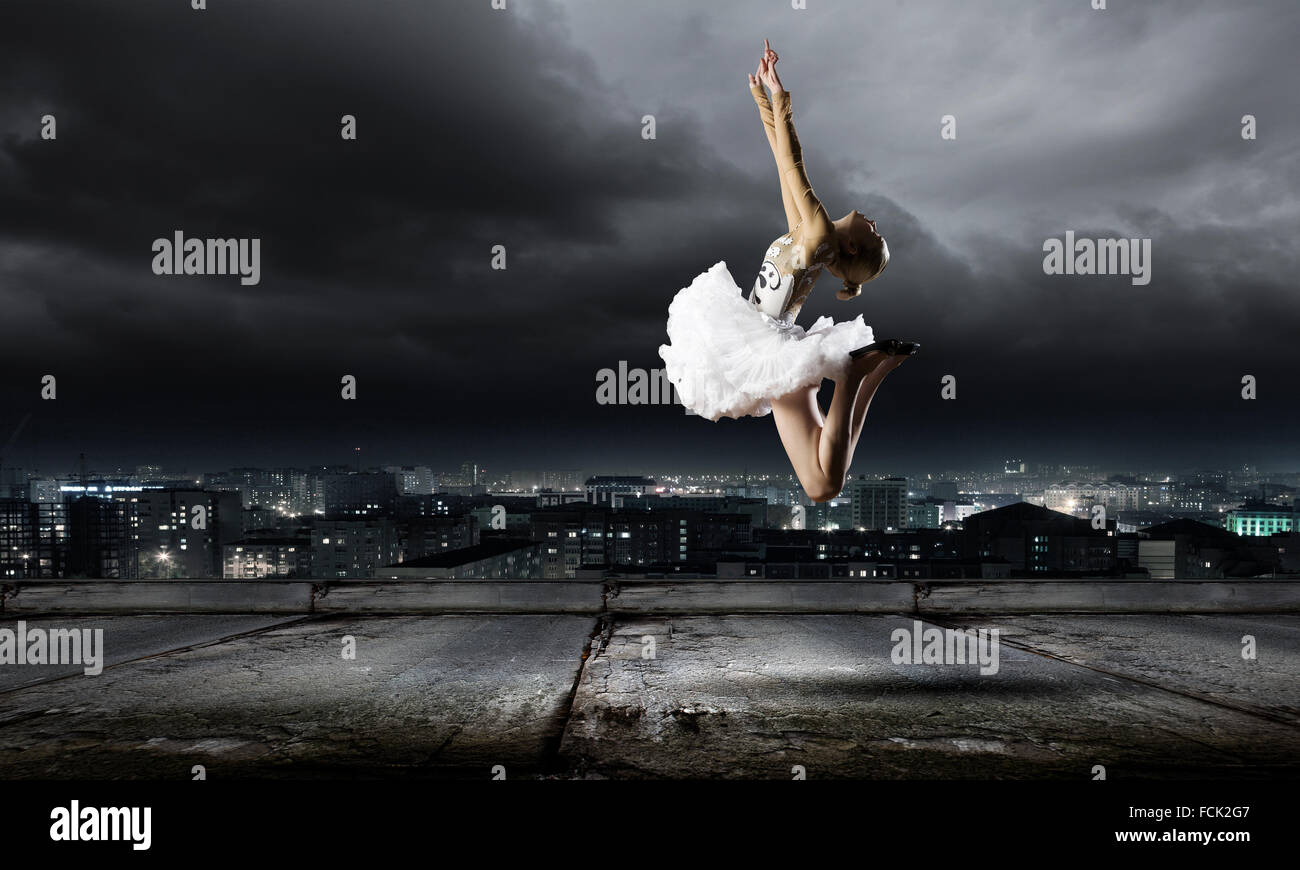 Young girl dancer jumping high in sky Stock Photo - Alamy