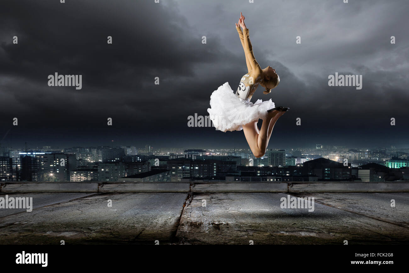 Young girl dancer jumping high in sky Stock Photo - Alamy
