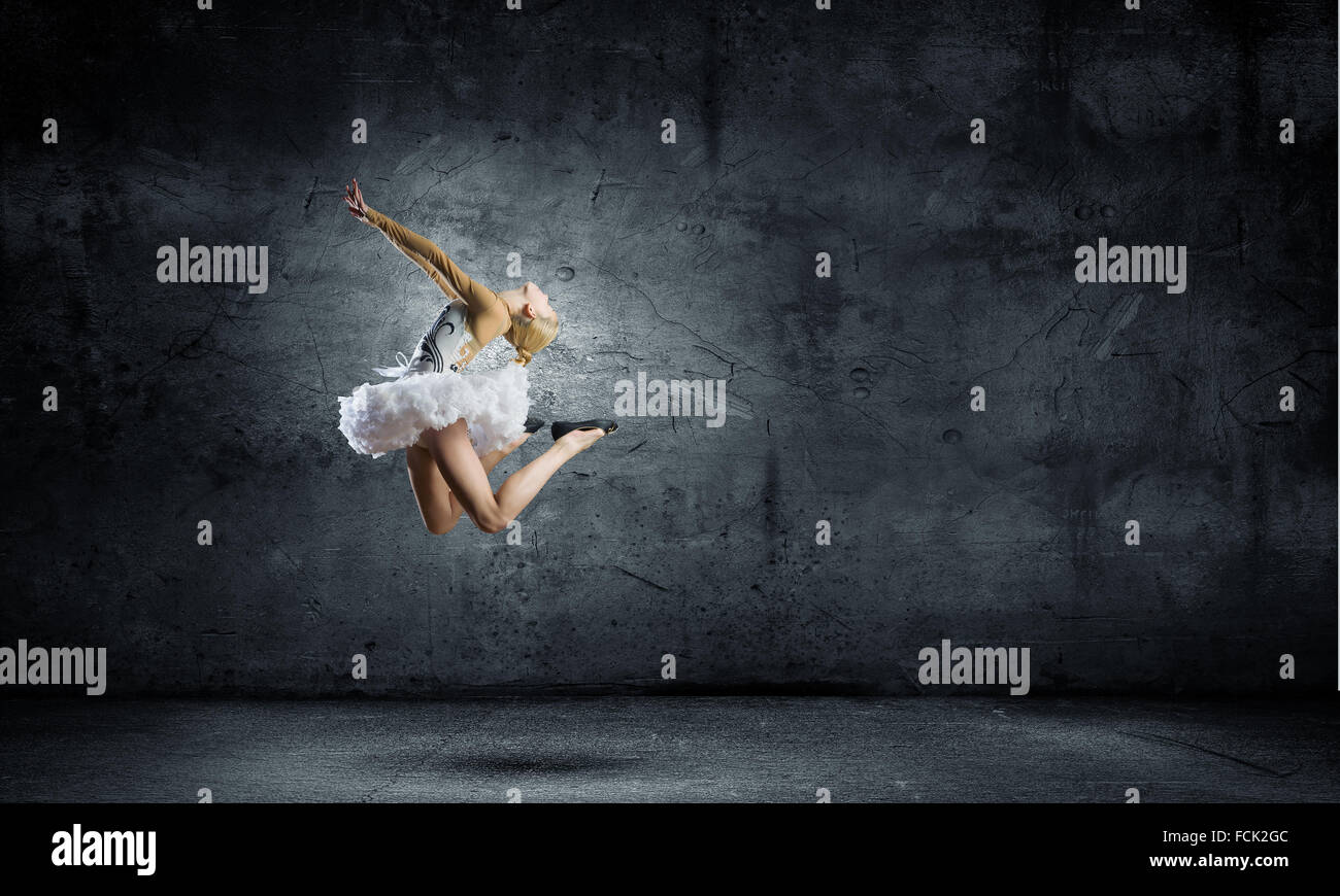 Young pretty ballerina girl making jump in dance Stock Photo - Alamy
