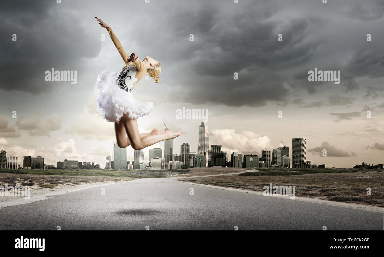 Young girl dancer jumping high in sky Stock Photo - Alamy