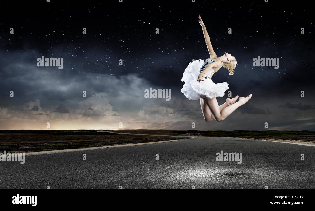 Young girl dancer jumping high in sky Stock Photo - Alamy