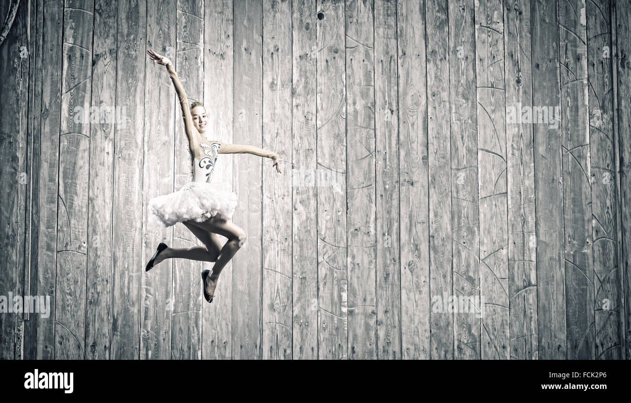 Young pretty ballerina girl making jump in dance Stock Photo - Alamy