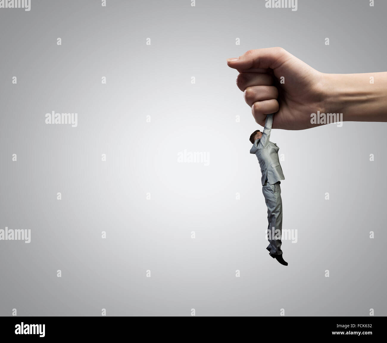 Close up of big human hand catching businessman Stock Photo - Alamy