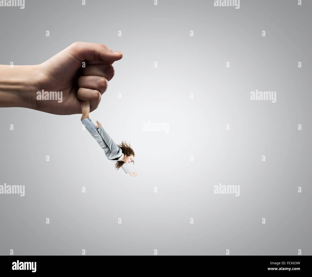 Close up of big human hand catching businesswoman Stock Photo - Alamy