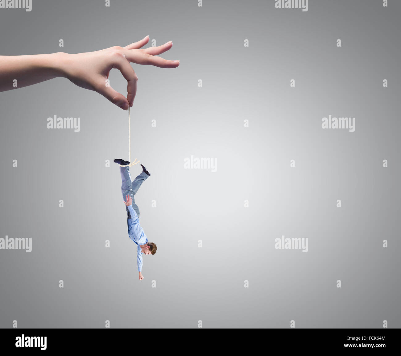 Close up of big human hand catching businessman Stock Photo - Alamy