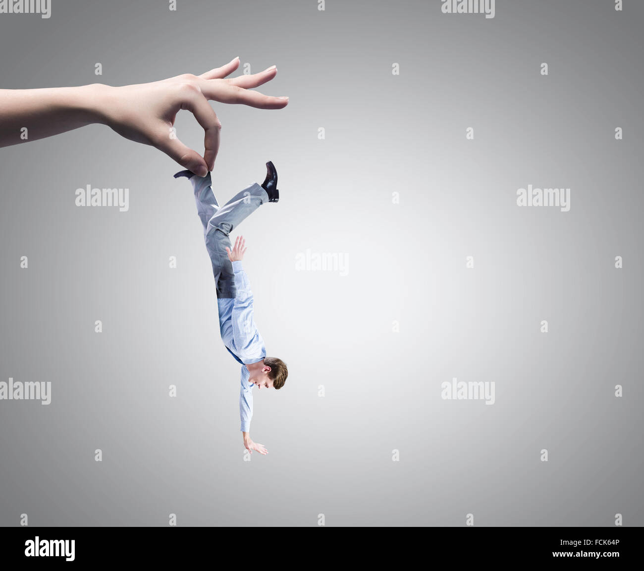 Close up of big human hand catching businessman Stock Photo - Alamy