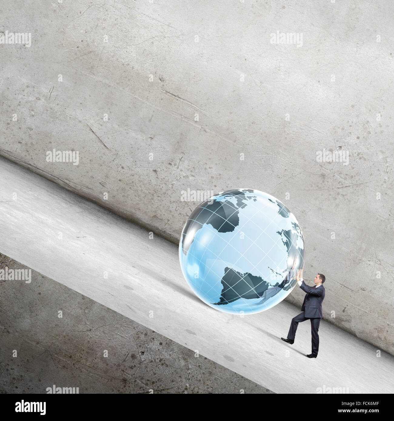 Young businessman rolling Earth planet up th hill Stock Photo - Alamy