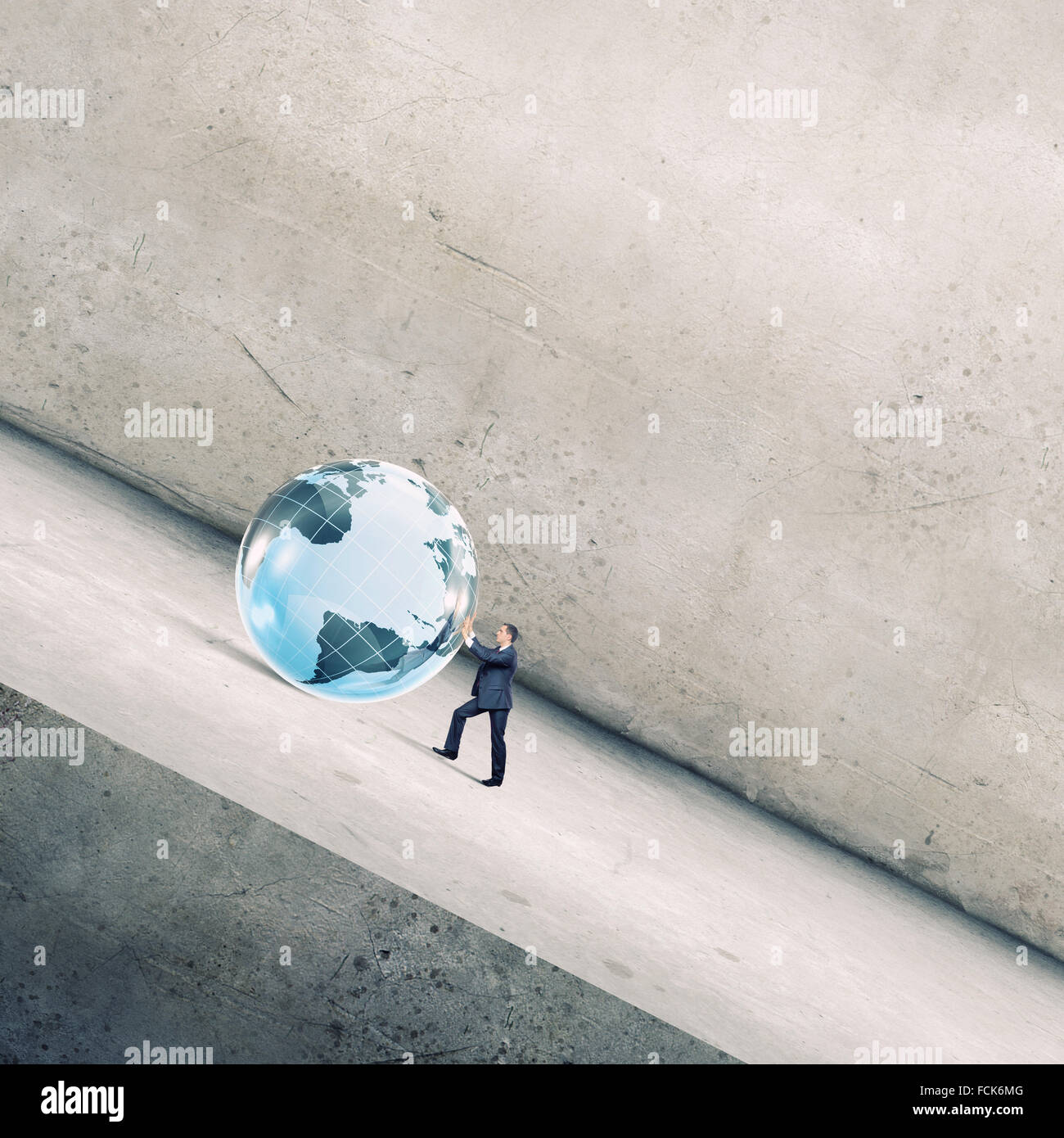 Young businessman rolling Earth planet up th hill Stock Photo - Alamy
