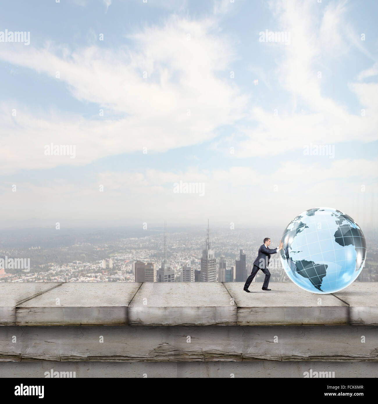 Young businessman rolling Earth planet up th hill Stock Photo - Alamy