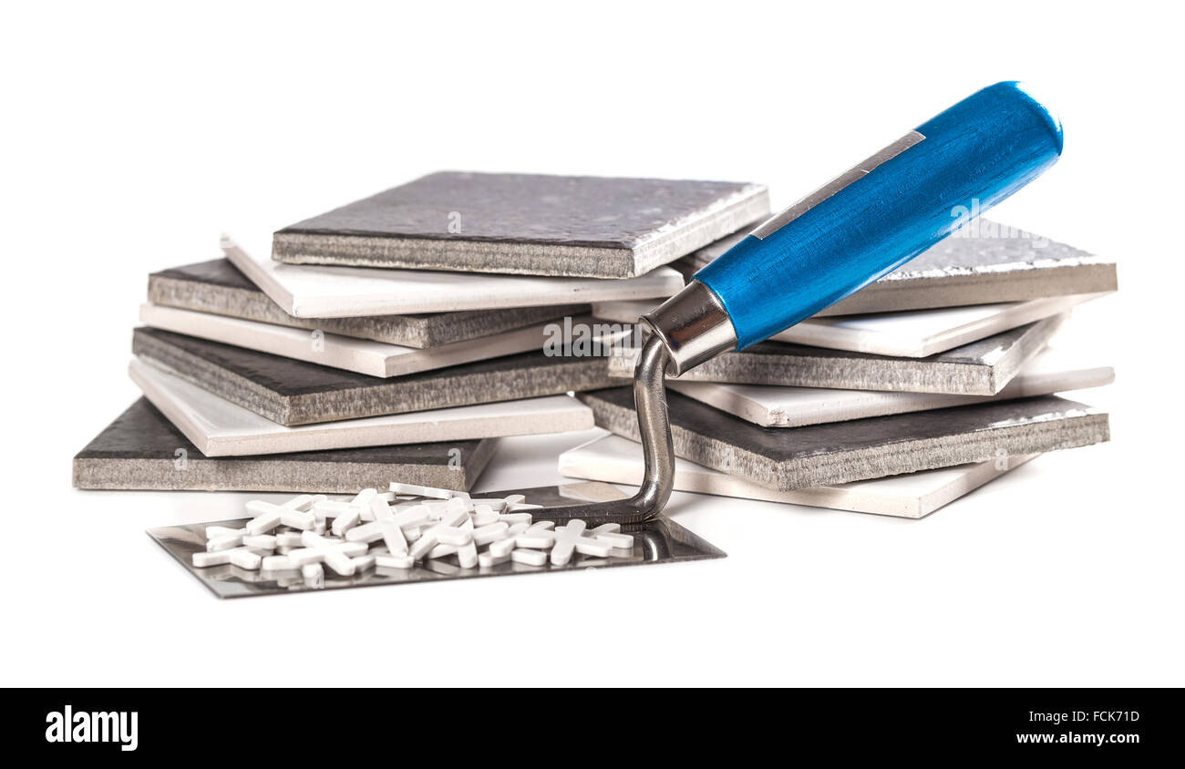 ceramic tiles and tools closeup on white background Stock Photo - Alamy