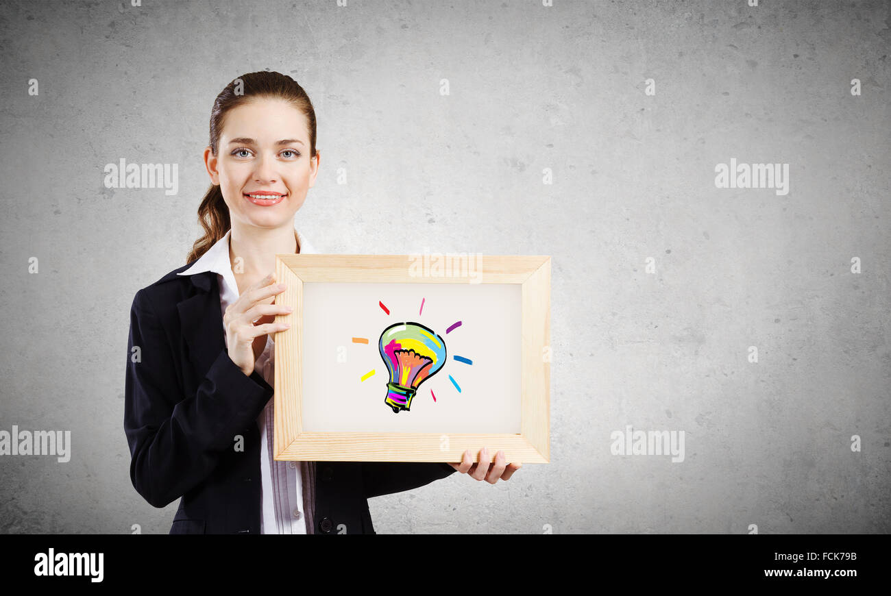 Young woman holding wooden frame with sketches Stock Photo - Alamy