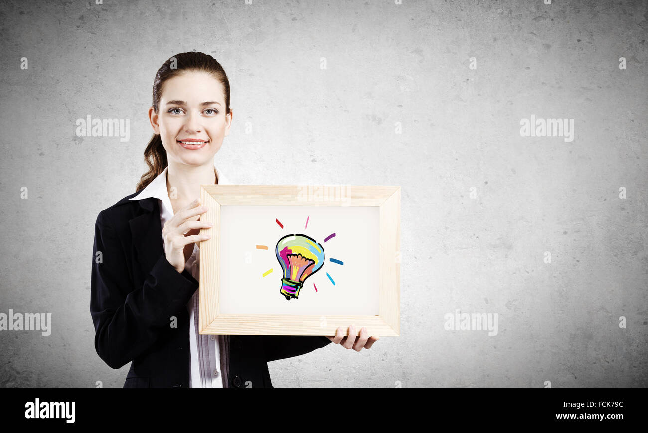 Young woman holding wooden frame with sketches Stock Photo - Alamy