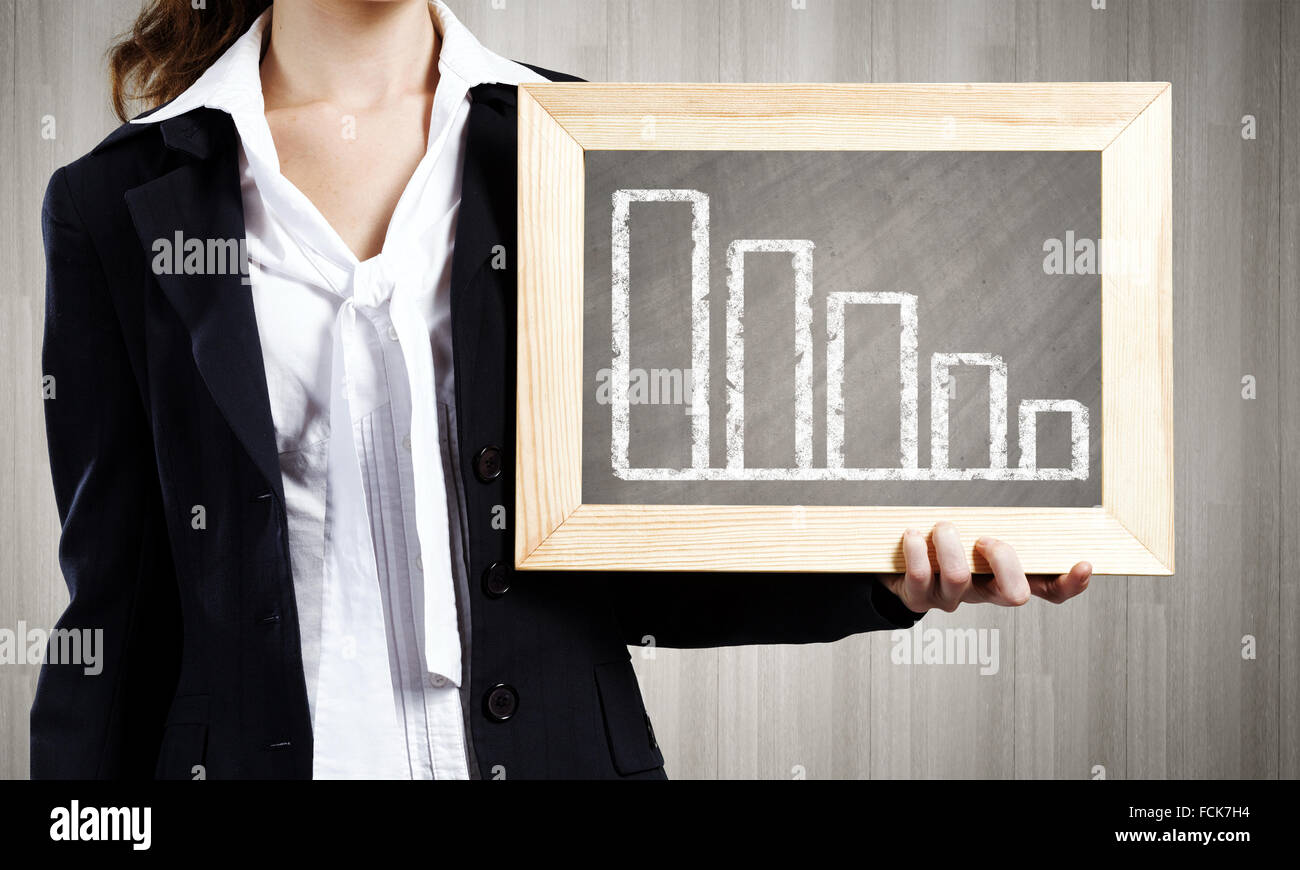 Young woman holding frame with decreasing graph Stock Photo - Alamy