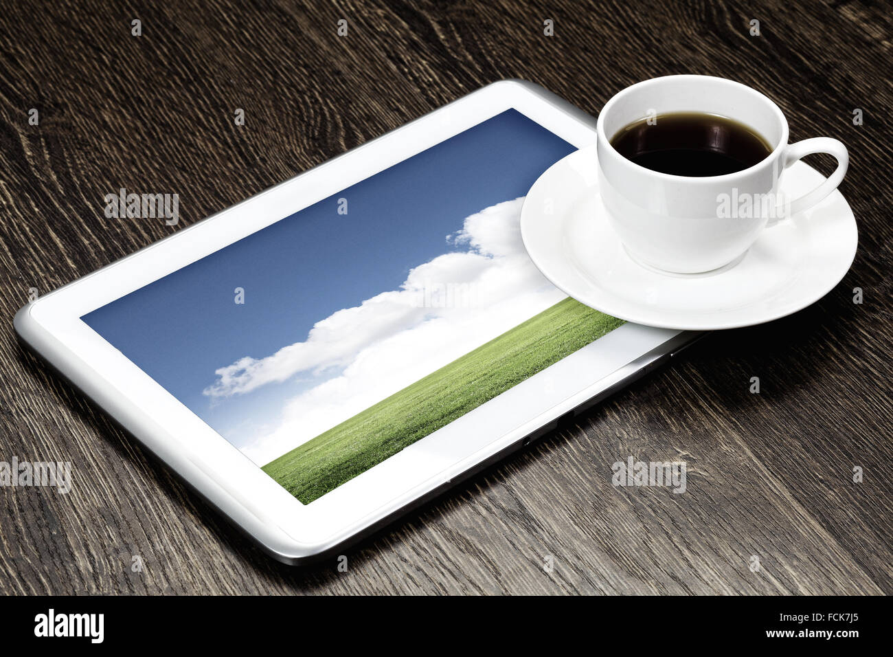 Tablet pc cup of coffee and notepad at table Stock Photo - Alamy
