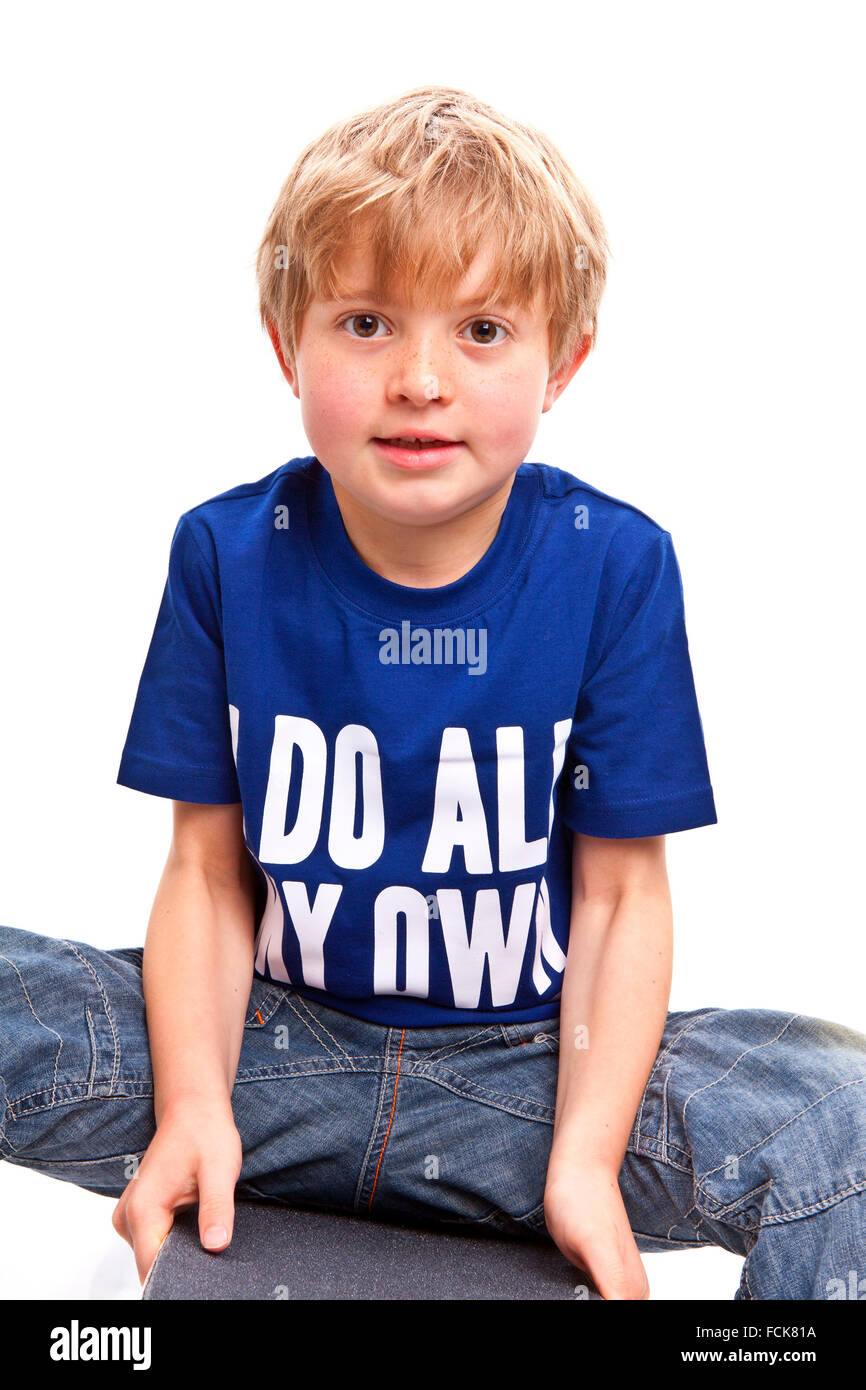 Young boy sat on skateboard on a white background Stock Photo - Alamy