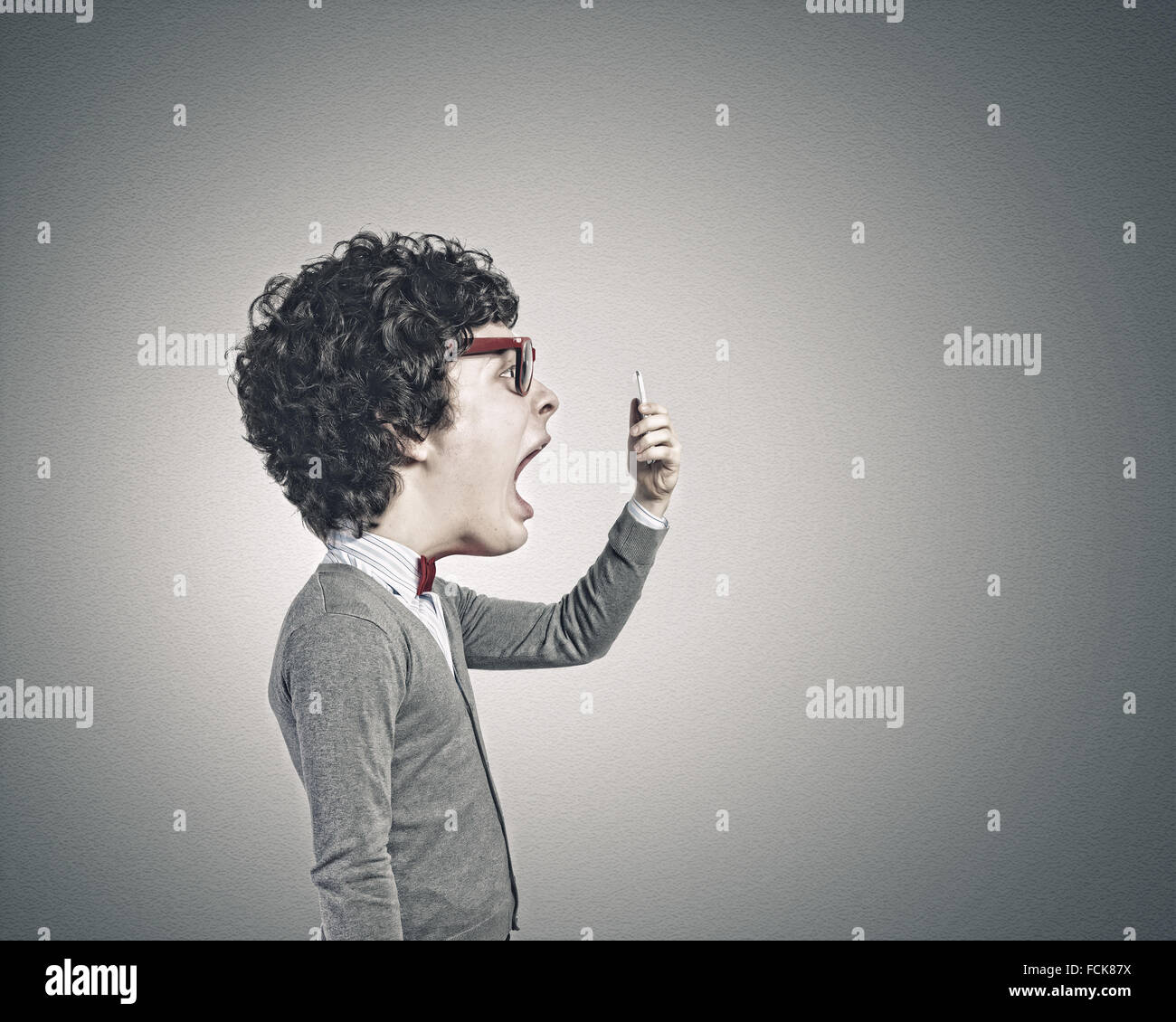 Funny young man with big head screaming emotional in mobile phone Stock ...