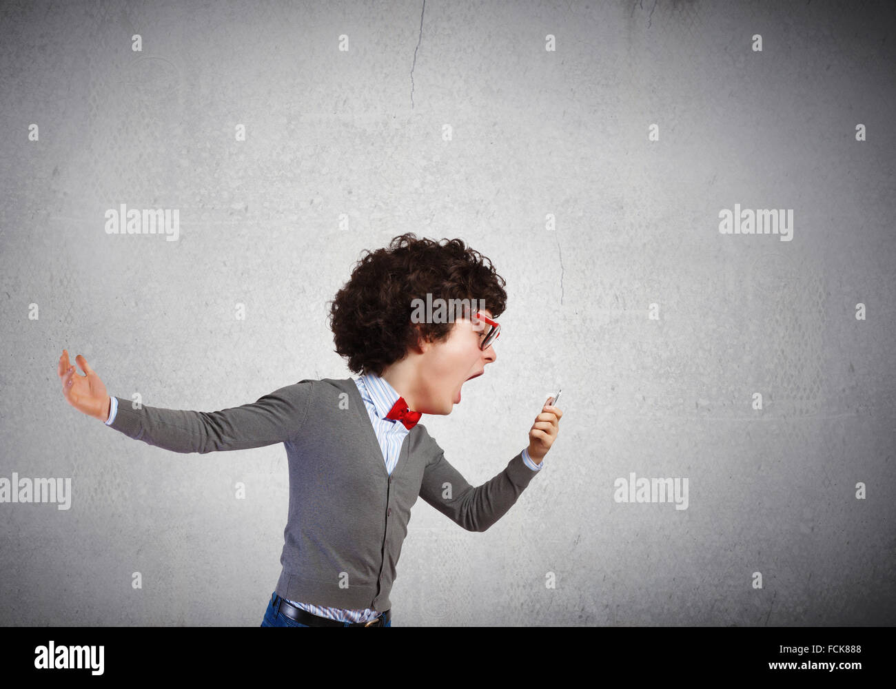 Funny young man with big head screaming emotional in mobile phone Stock ...