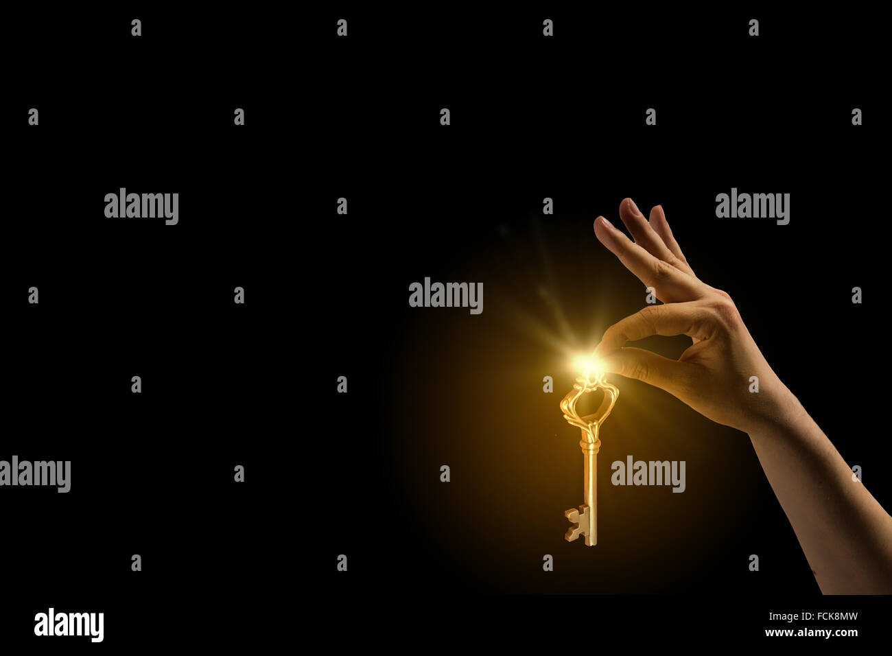 Close up of human hand catching golden key Stock Photo - Alamy