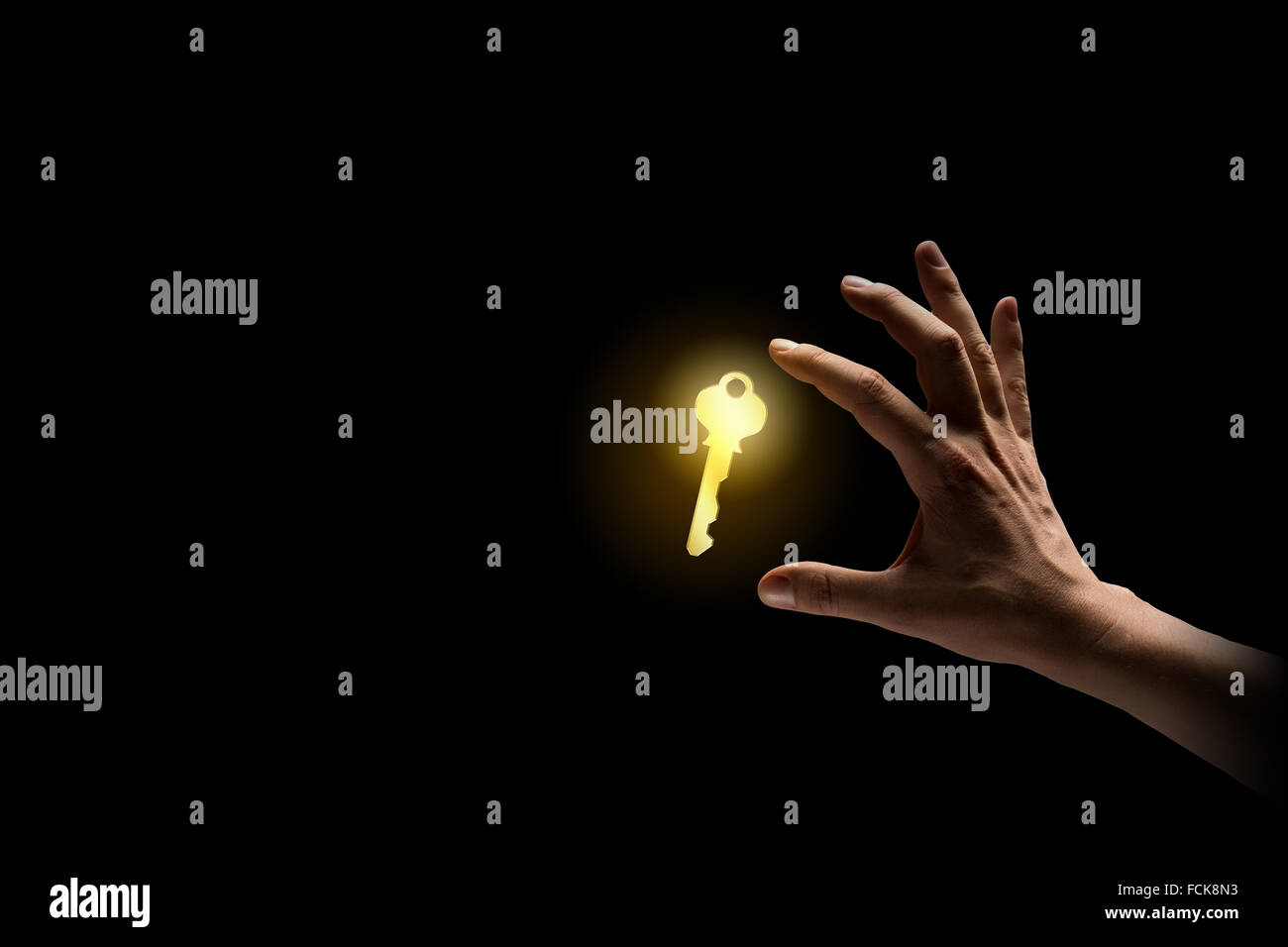 Close up of human hand catching golden key Stock Photo - Alamy