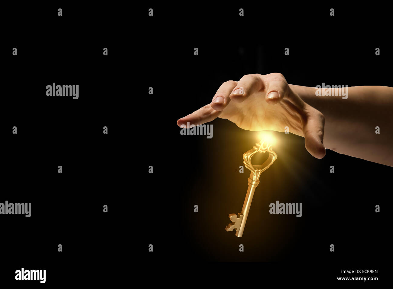Close up of human hand catching golden key Stock Photo - Alamy