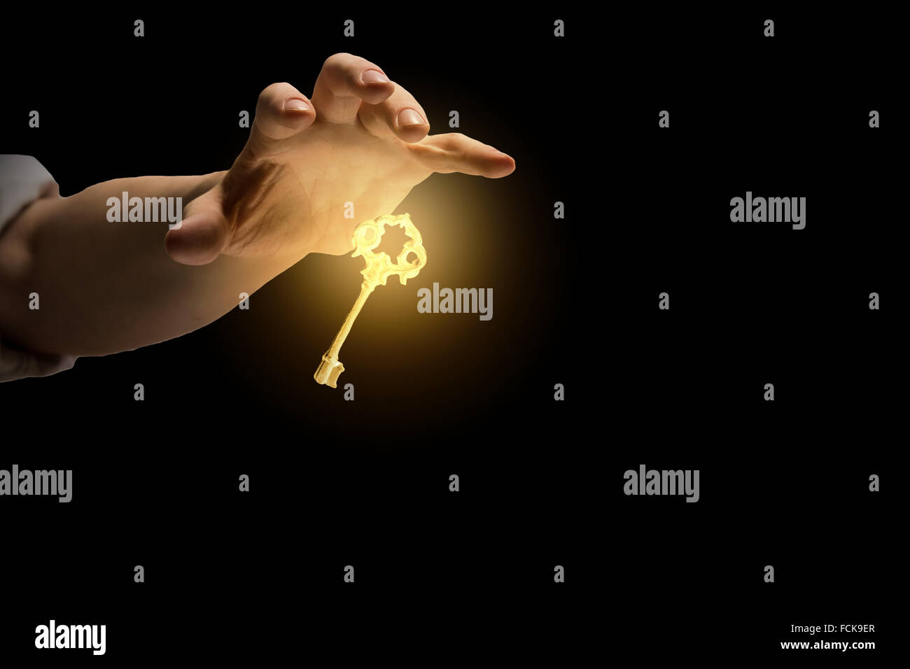 Close up of human hand catching golden key Stock Photo - Alamy