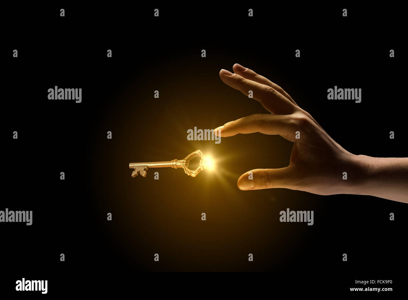 Close up of human hand catching golden key Stock Photo - Alamy