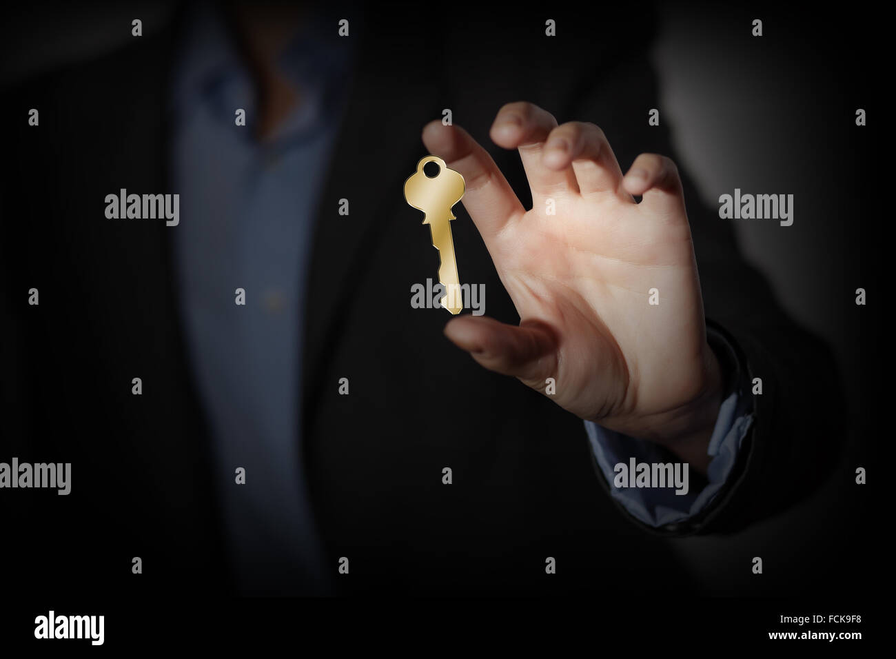 Close up of human hand catching golden key Stock Photo - Alamy