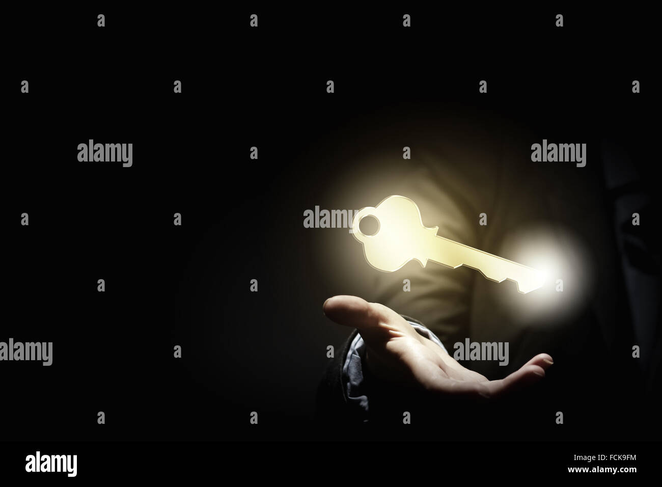 Close up of human hand holding golden key Stock Photo - Alamy