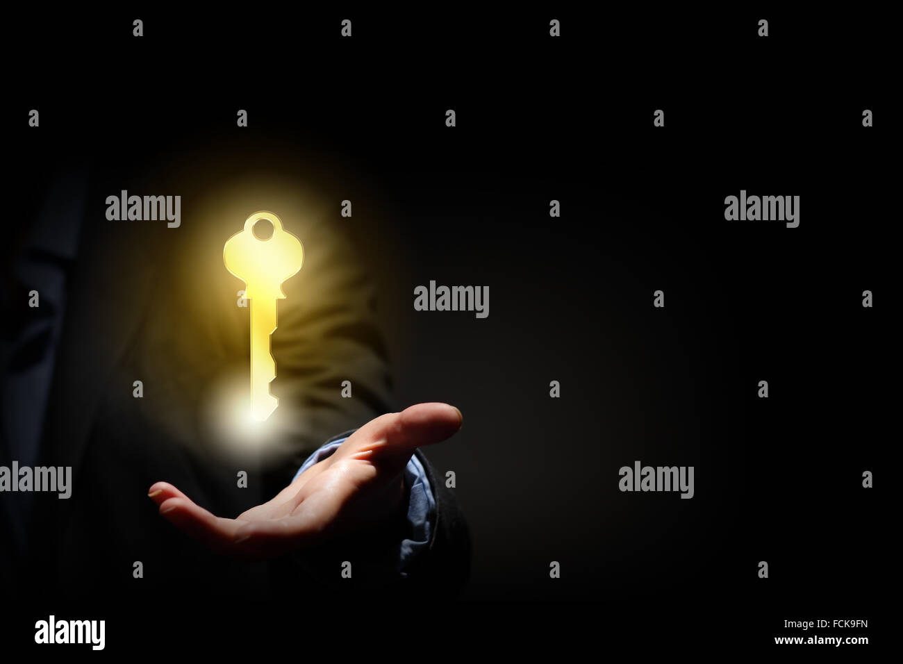 Close up of human hand holding golden key Stock Photo - Alamy