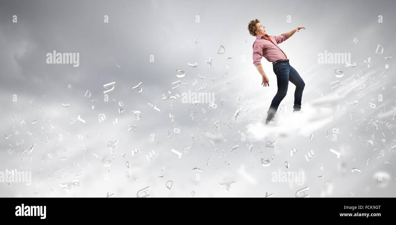 Young man walking on cloud high in sky Stock Photo - Alamy