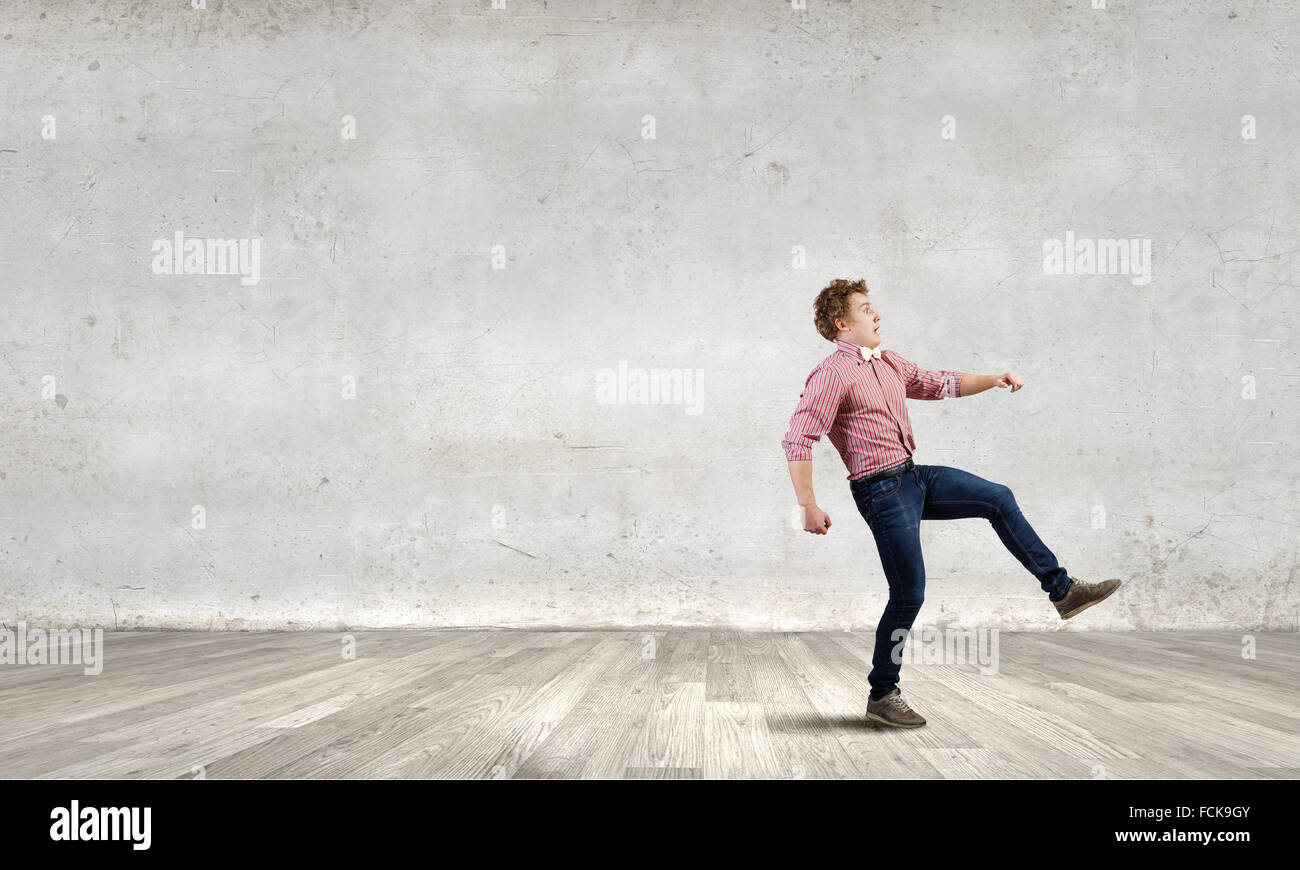 Young man in casual running away from something Stock Photo - Alamy