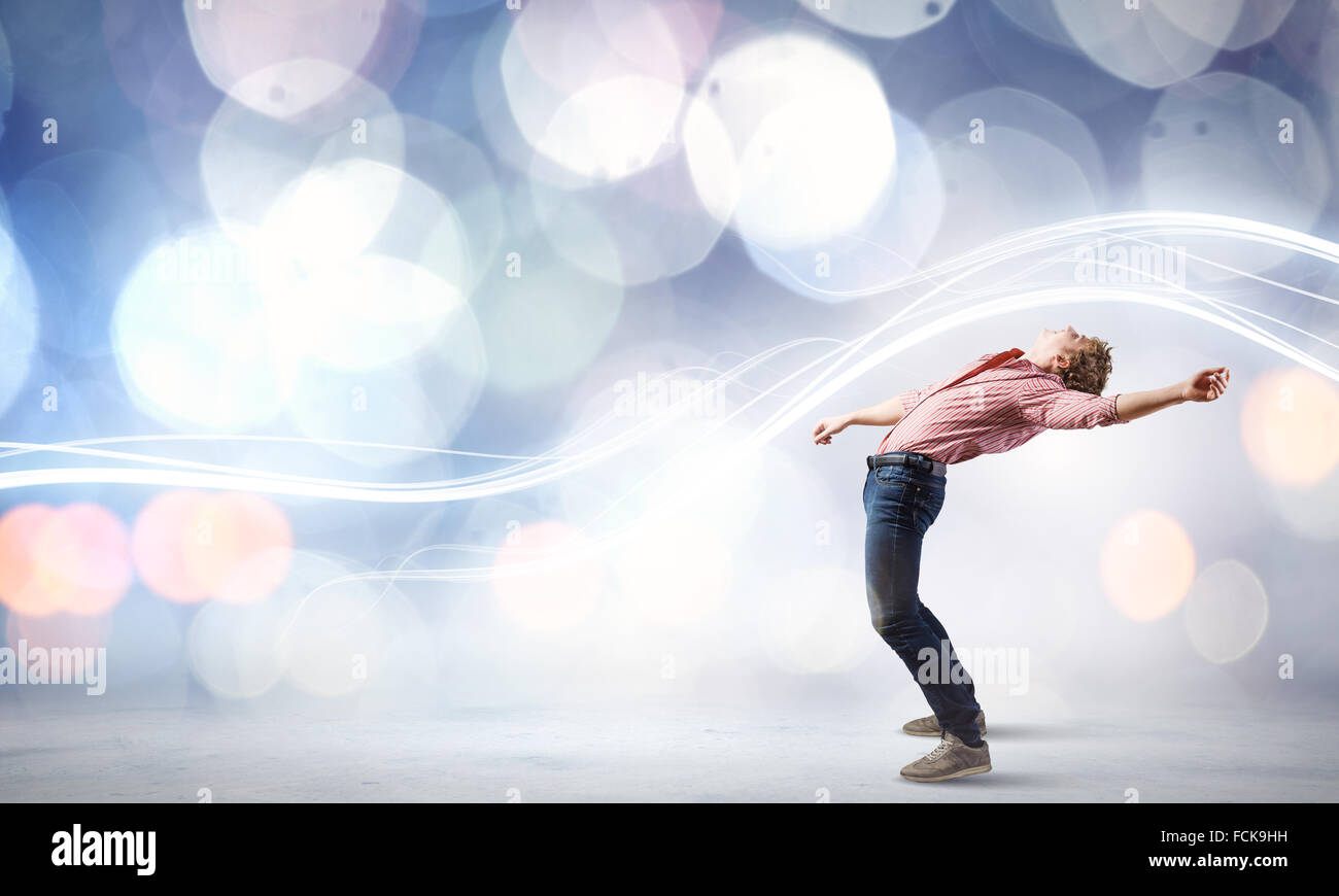 Young guy in casual evading from light rays Stock Photo - Alamy