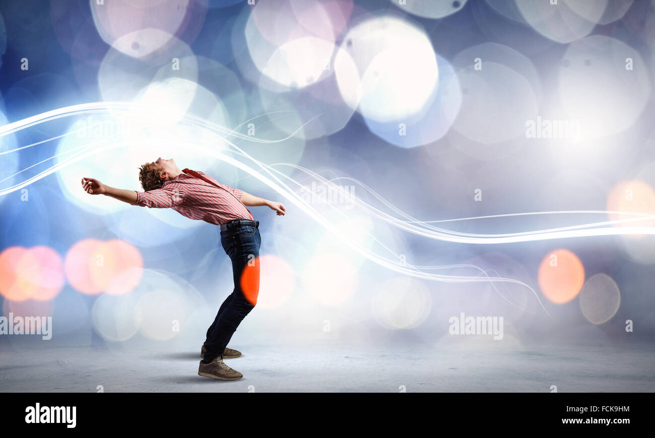 Young guy in casual evading from light rays Stock Photo - Alamy