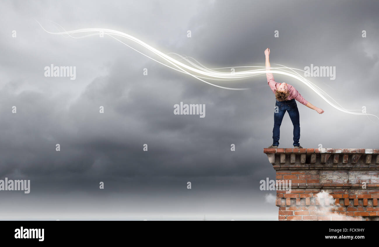 Young guy in casual evading from light rays Stock Photo - Alamy