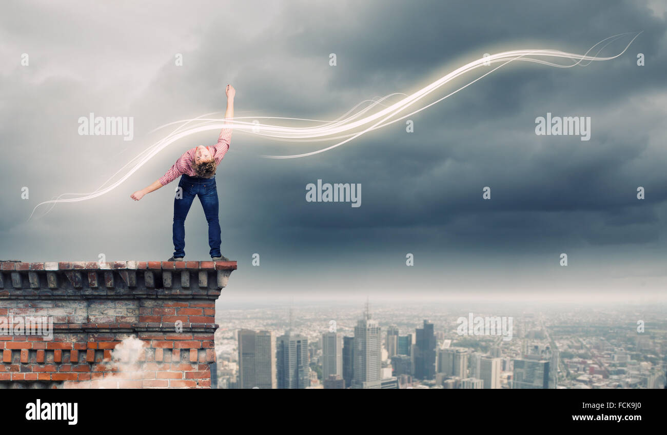 Young guy in casual evading from light rays Stock Photo - Alamy