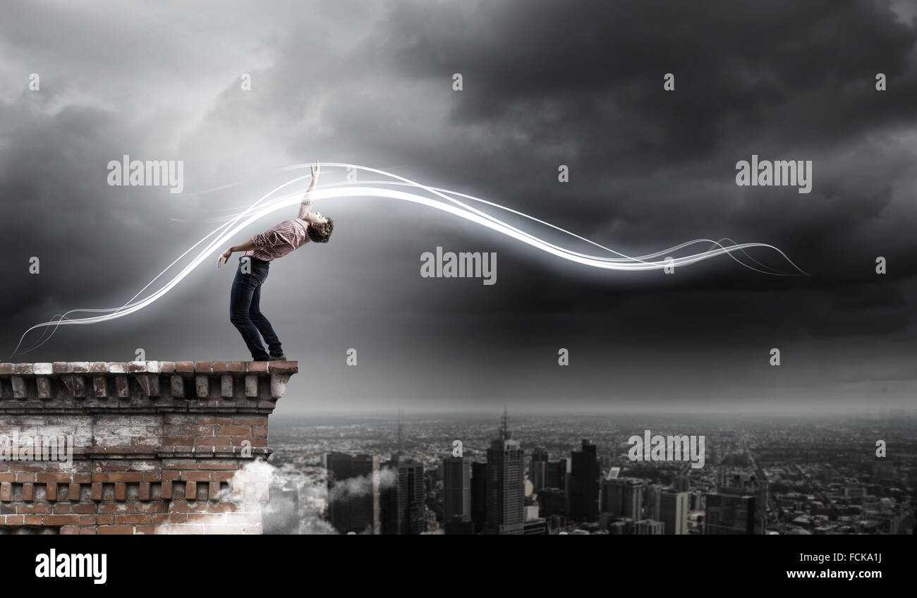 Young guy in casual evading from light rays Stock Photo - Alamy